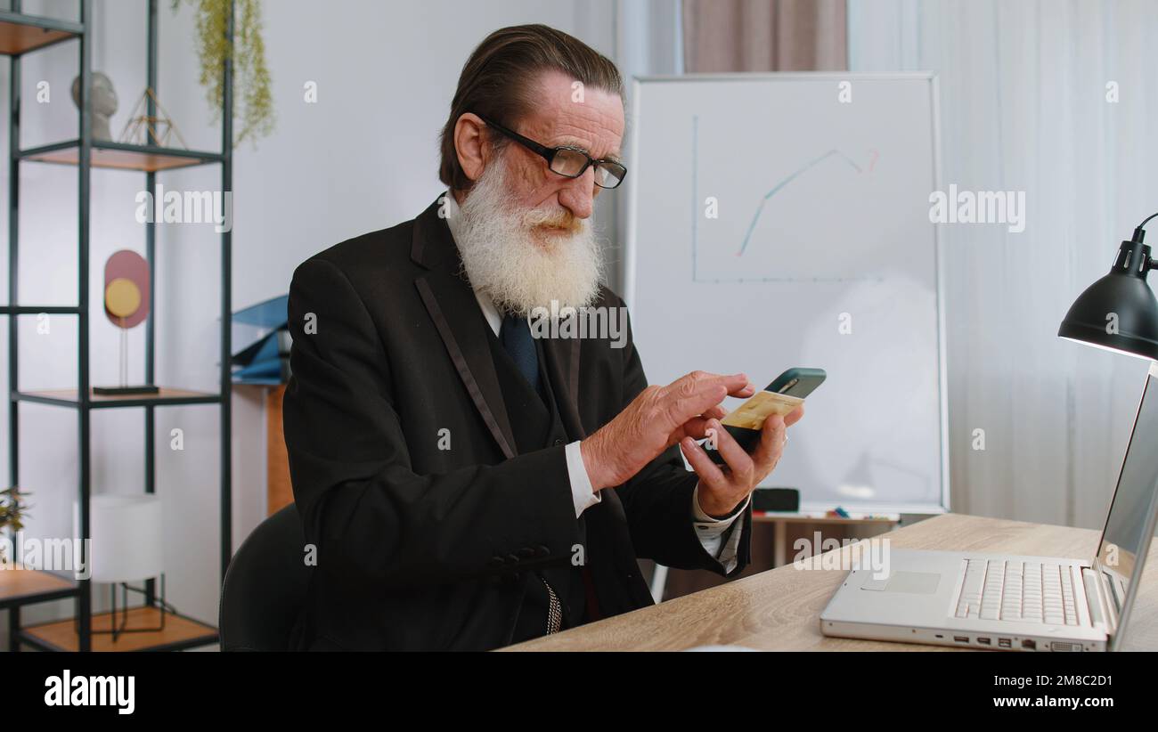 Elderly businessman programmer software developer working making online ...