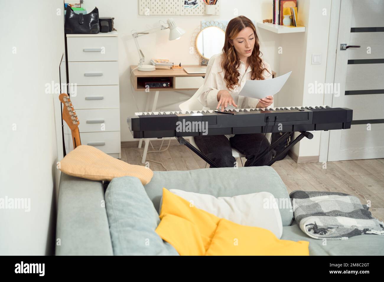 Focused musician involved in writing musical composition Stock Photo ...