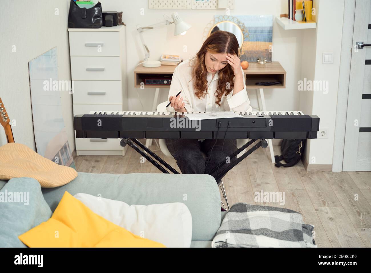 Focused female composer creating new musical composition Stock Photo ...