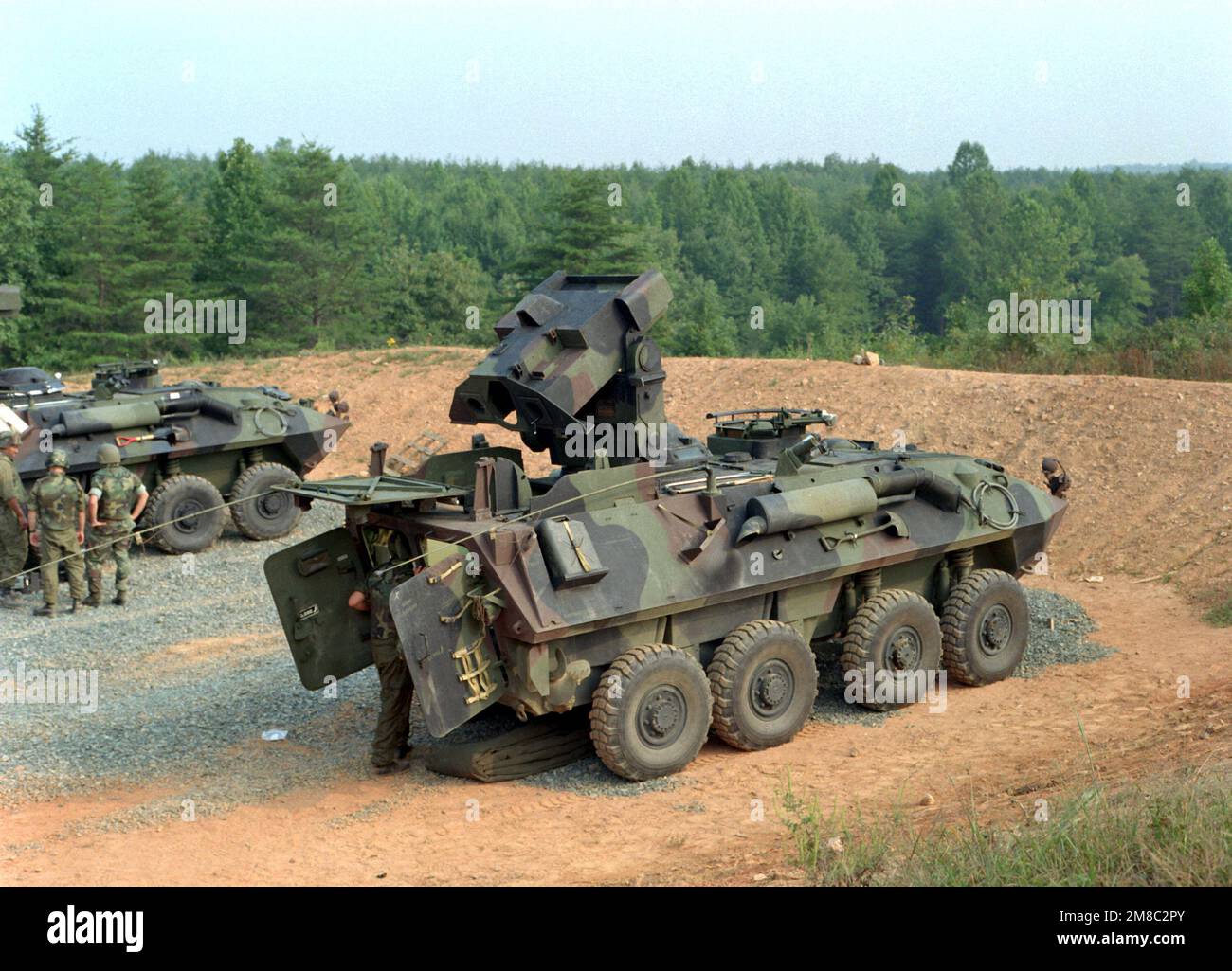 SGT. John Tillman stands at the open rear doors of an LAV(AT)-25 light ...