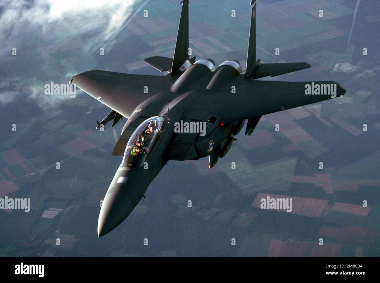 A 336th Tactical Fighter Squadron F-15E Eagle aircraft follows behind a ...