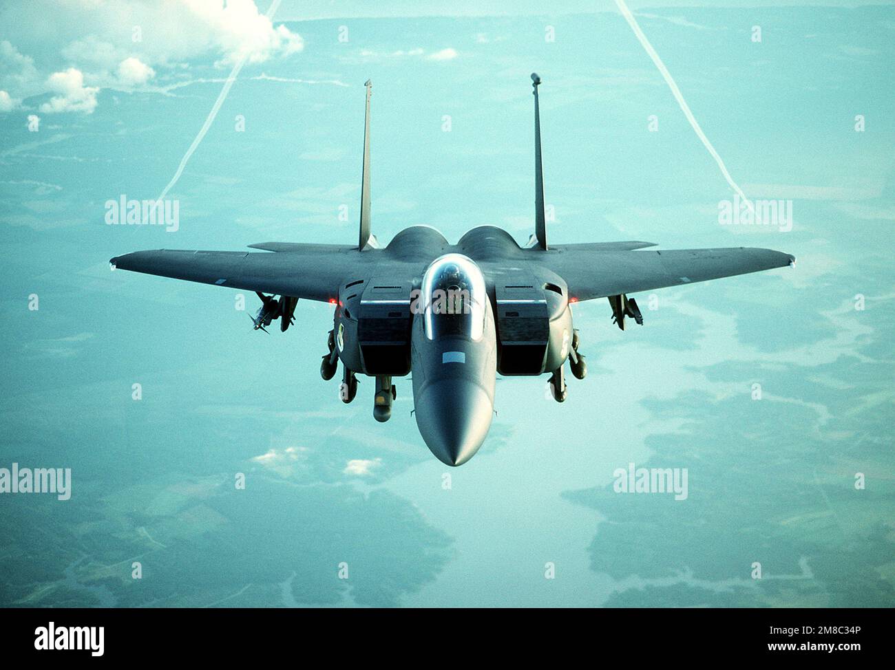 A 336th Tactical Fighter Squadron F-15E Eagle aircraft follows behind a ...