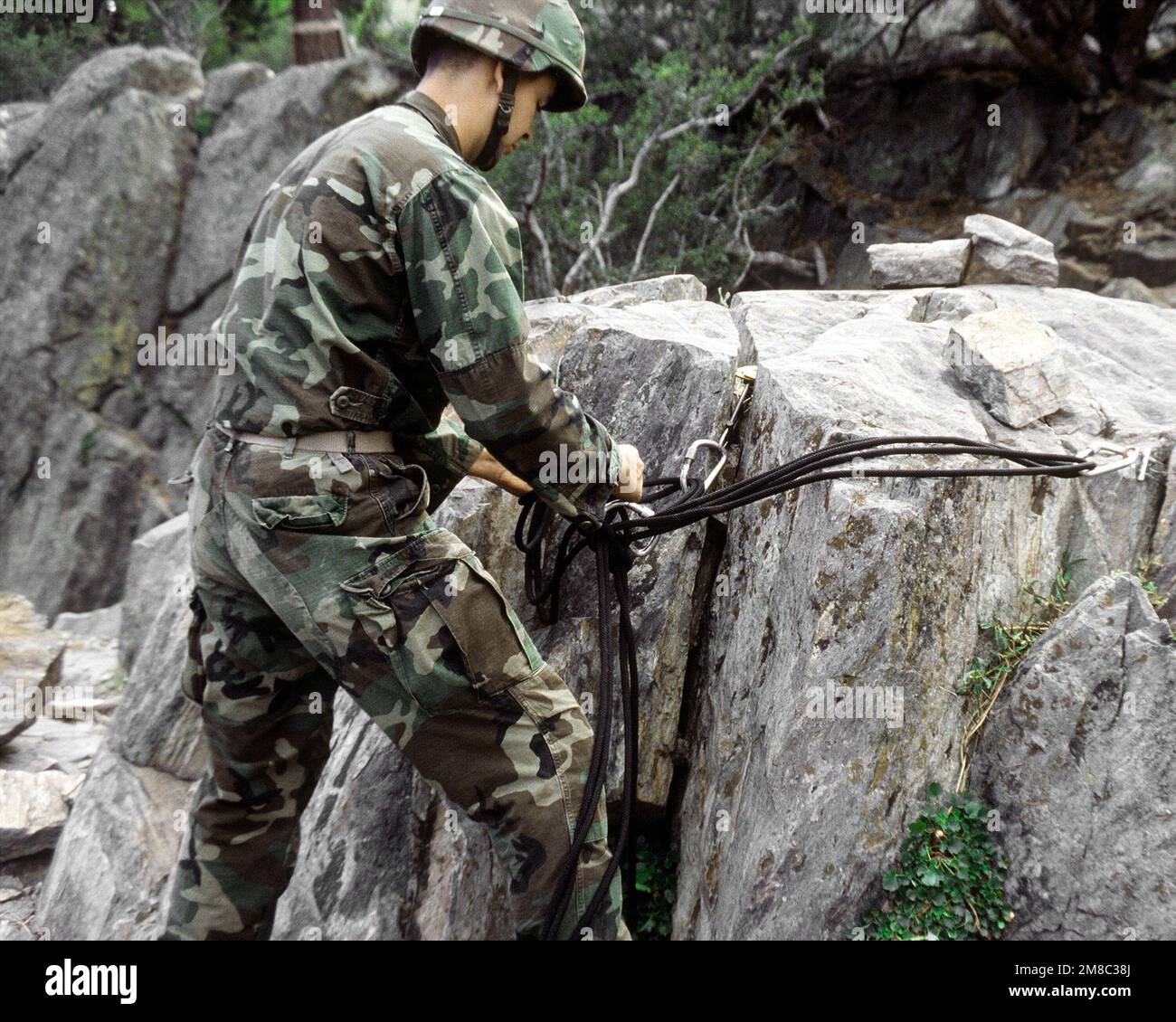A member of the 3rd Battalion, 9th Marines, anchors his line in a crack ...