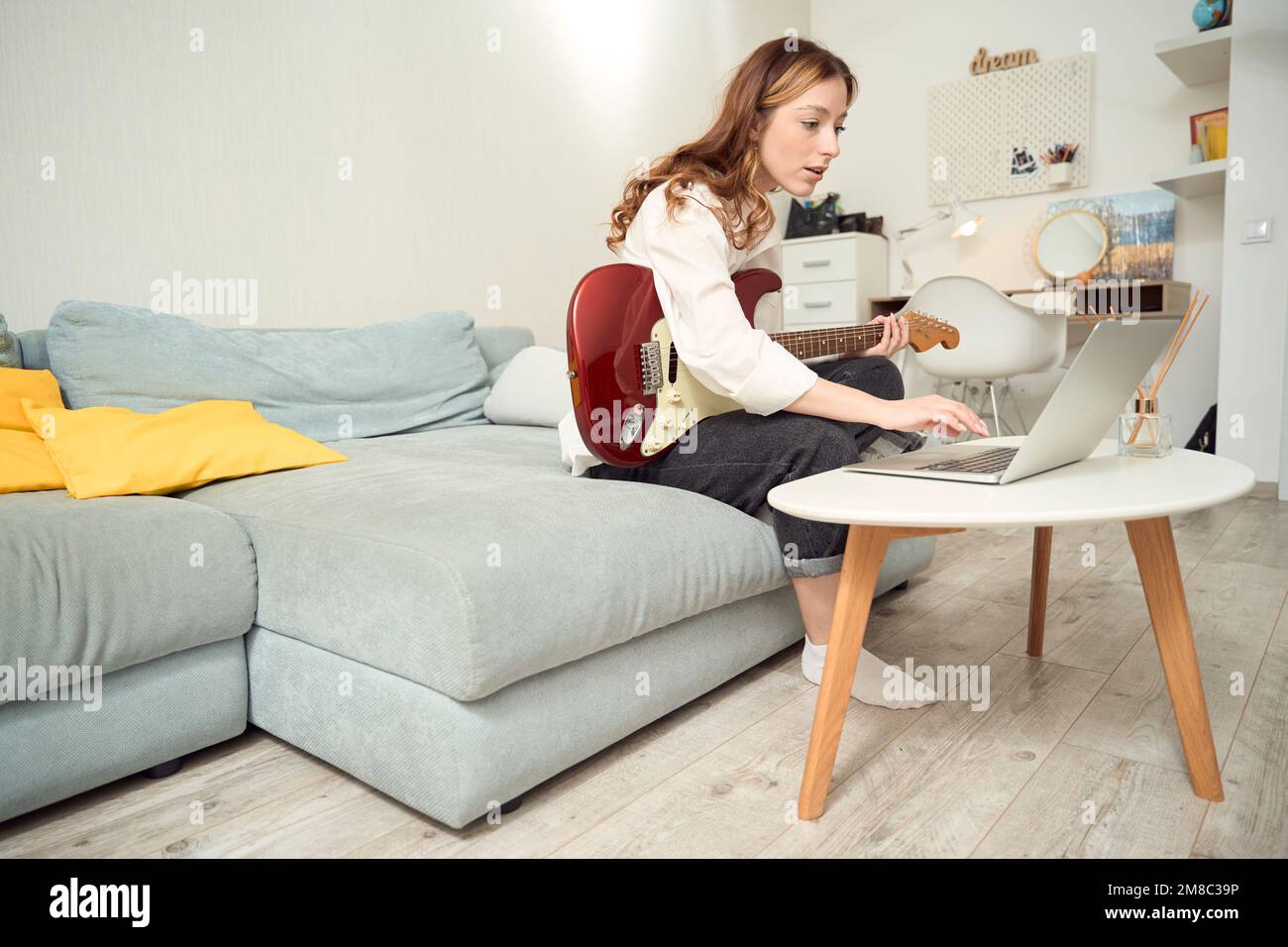 Focused lady preparing to play musical instrument in room Stock Photo ...