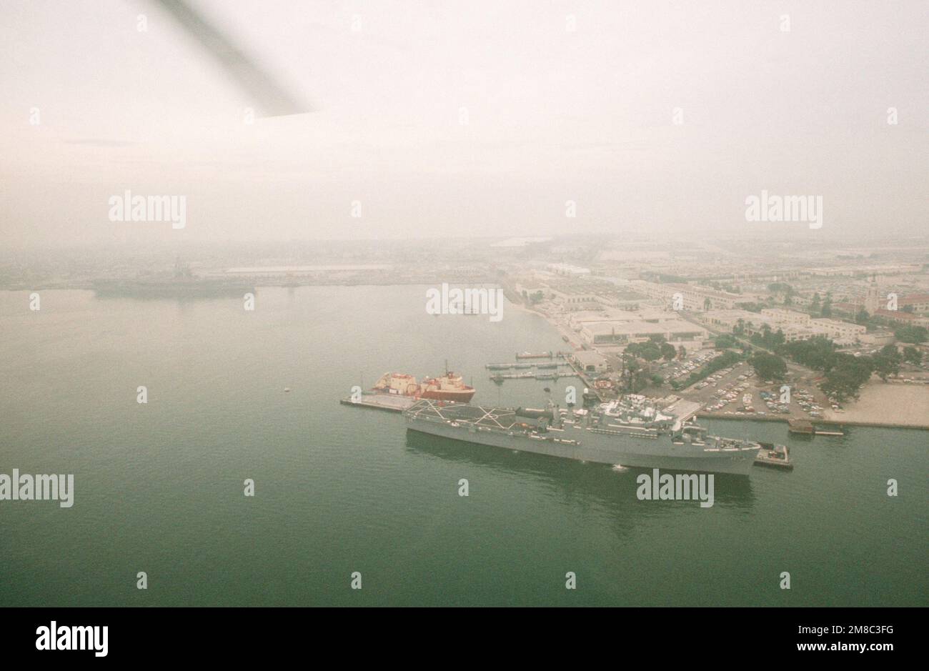 An aerial view of the command ship USS CORONADO (AGF 11) in port during ...
