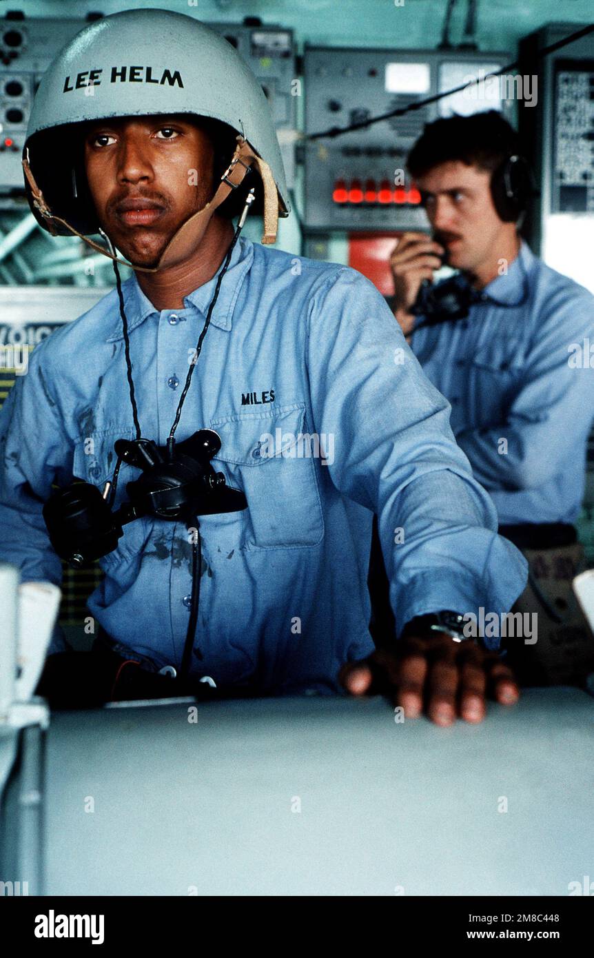 Two telephone talkers man their stations on the bridge of the ...