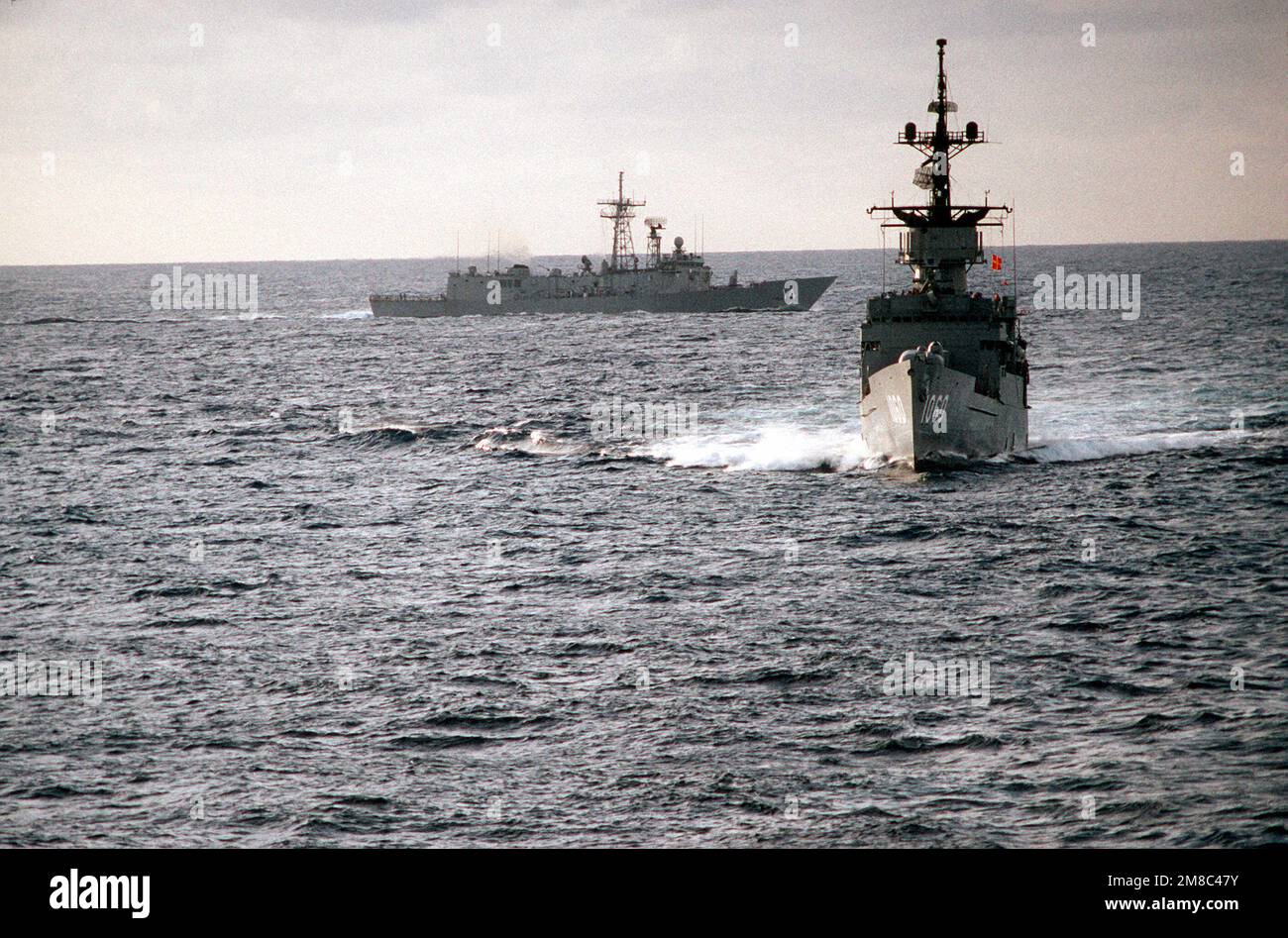 The frigate USS LANG (FF 1060) and the guided missile frigate USS JOHN ...