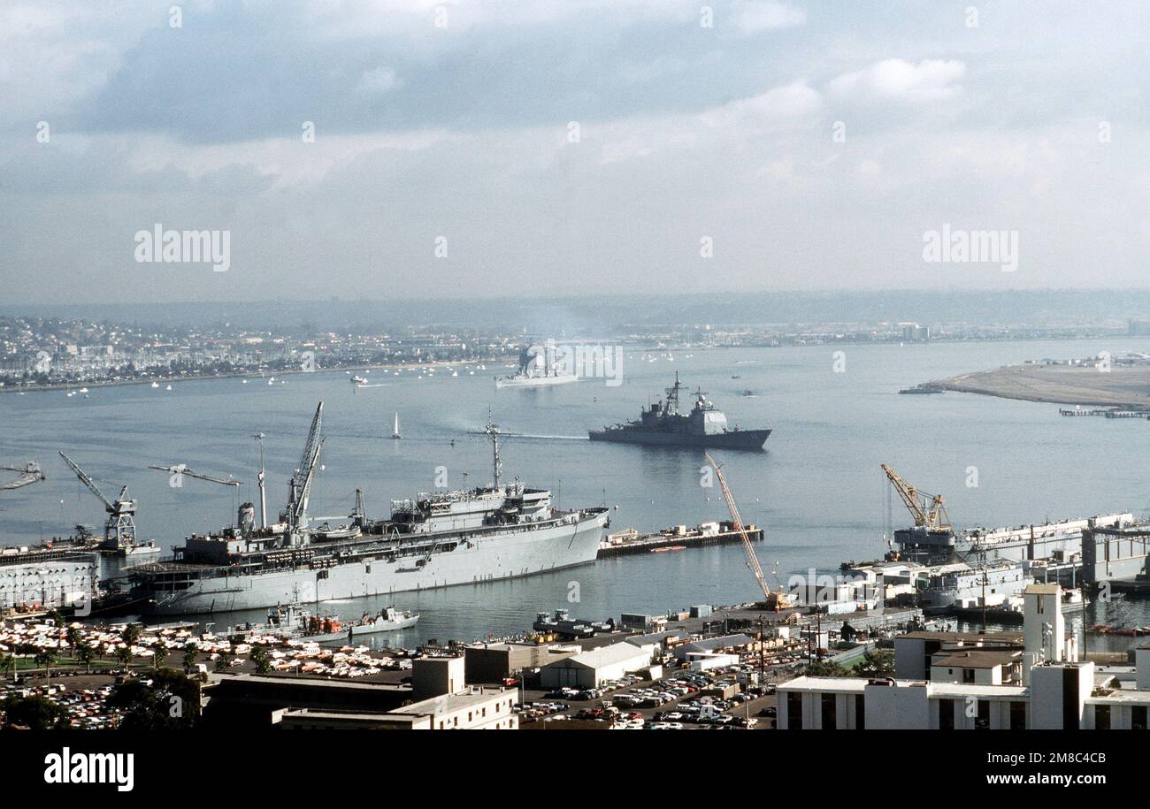 The submarine tender USS DIXON (AS 37) sits at the dock as the guided ...