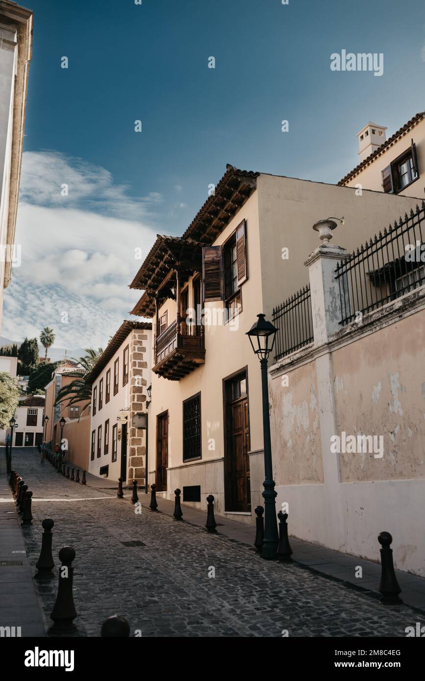 A vertical shot of a narrow road between modern residential buildings ...