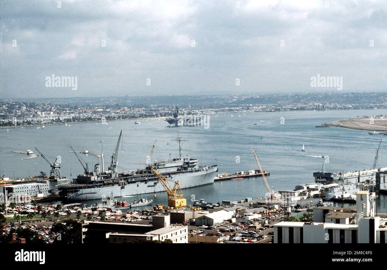 The submarine tender USS DIXON (AS 37) sits at the dock as the aircraft ...