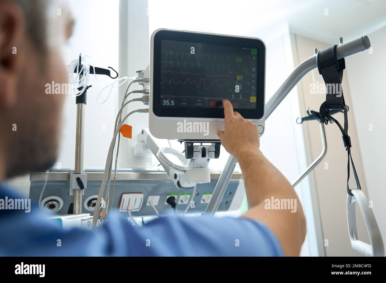 Close up photo of doctor looking at medical device Stock Photo - Alamy