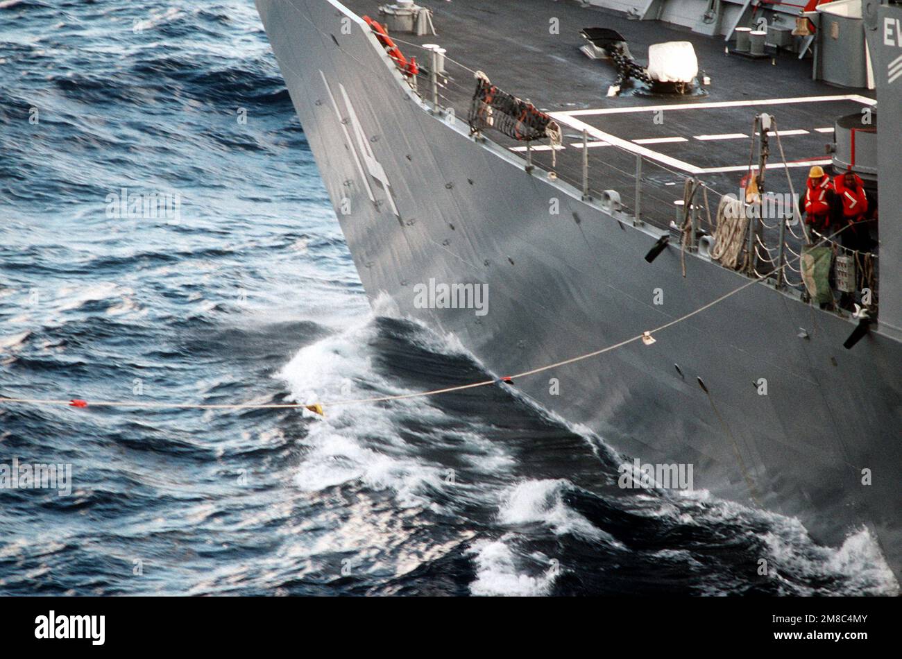 A sailor handles a line on the guided missile frigate USS JOHN H. SIDES ...