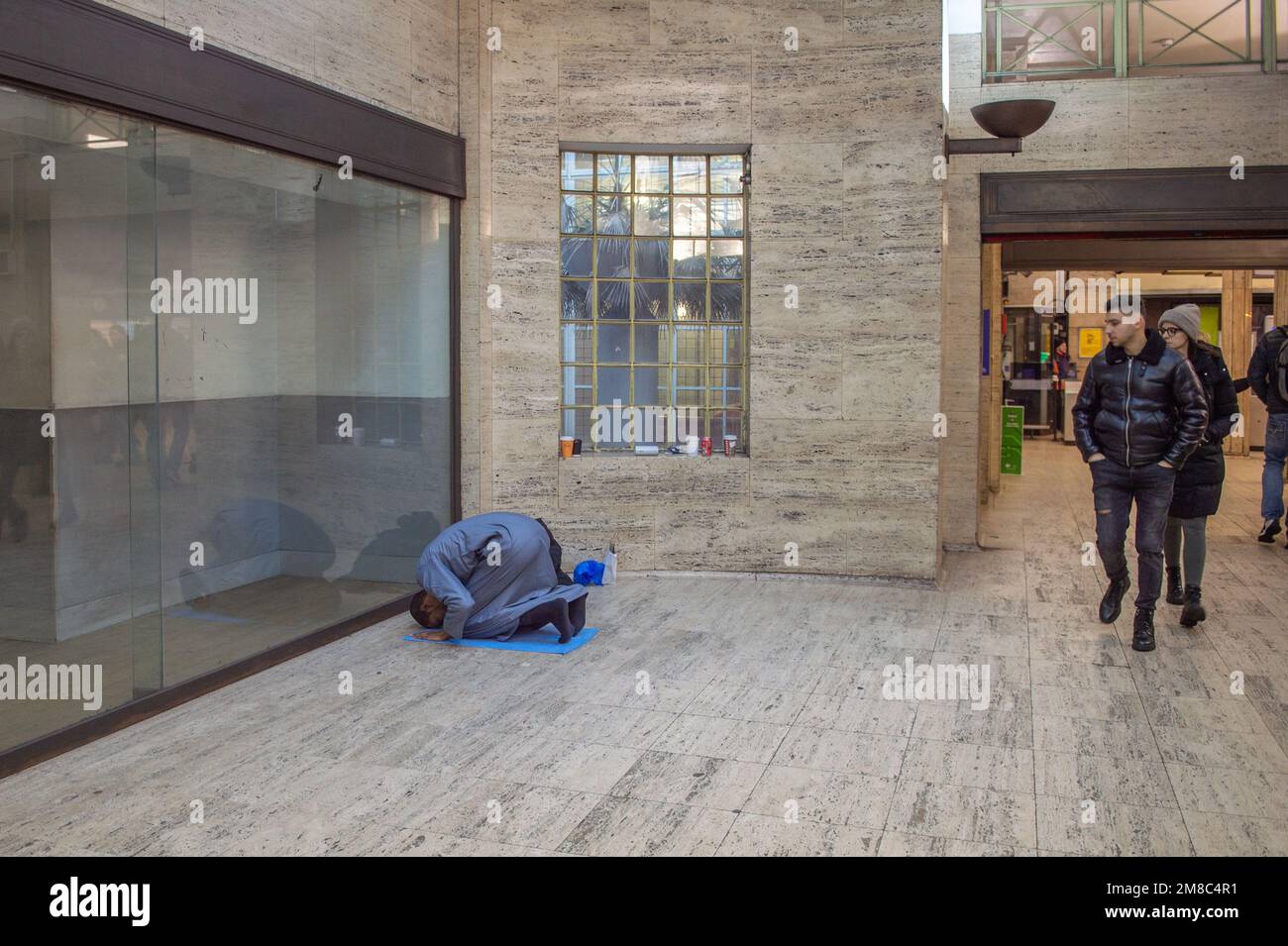 A muslim man prayers in the entrance to St James Park tube station ...