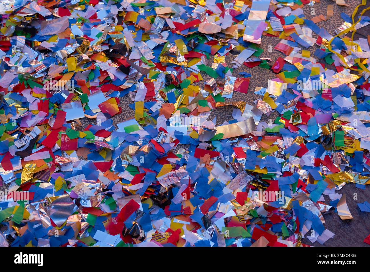 Colourful confetti scattered on floor and left after the celebration ...