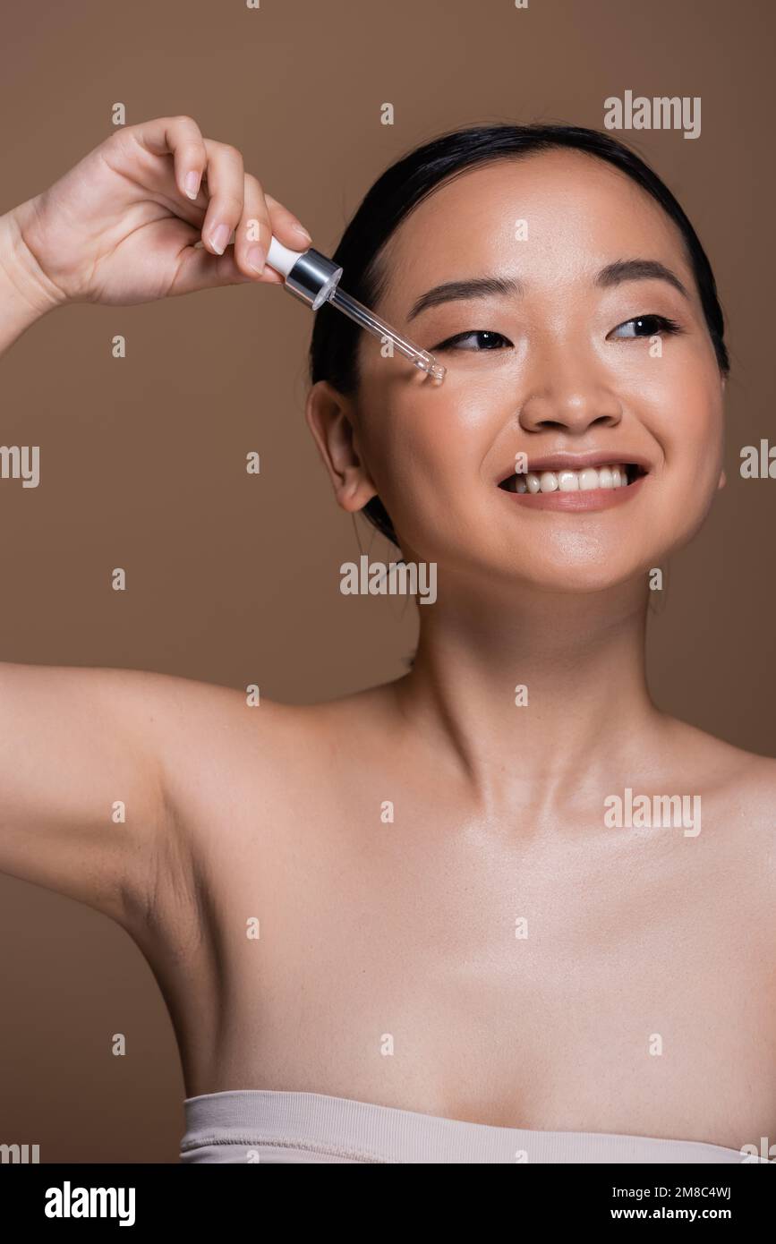 Asian woman applying serum hi-res stock photography and images - Alamy