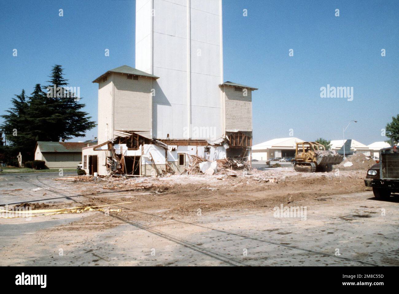 A bulldozer clears rubble from the area as the old parachute shop on A ...