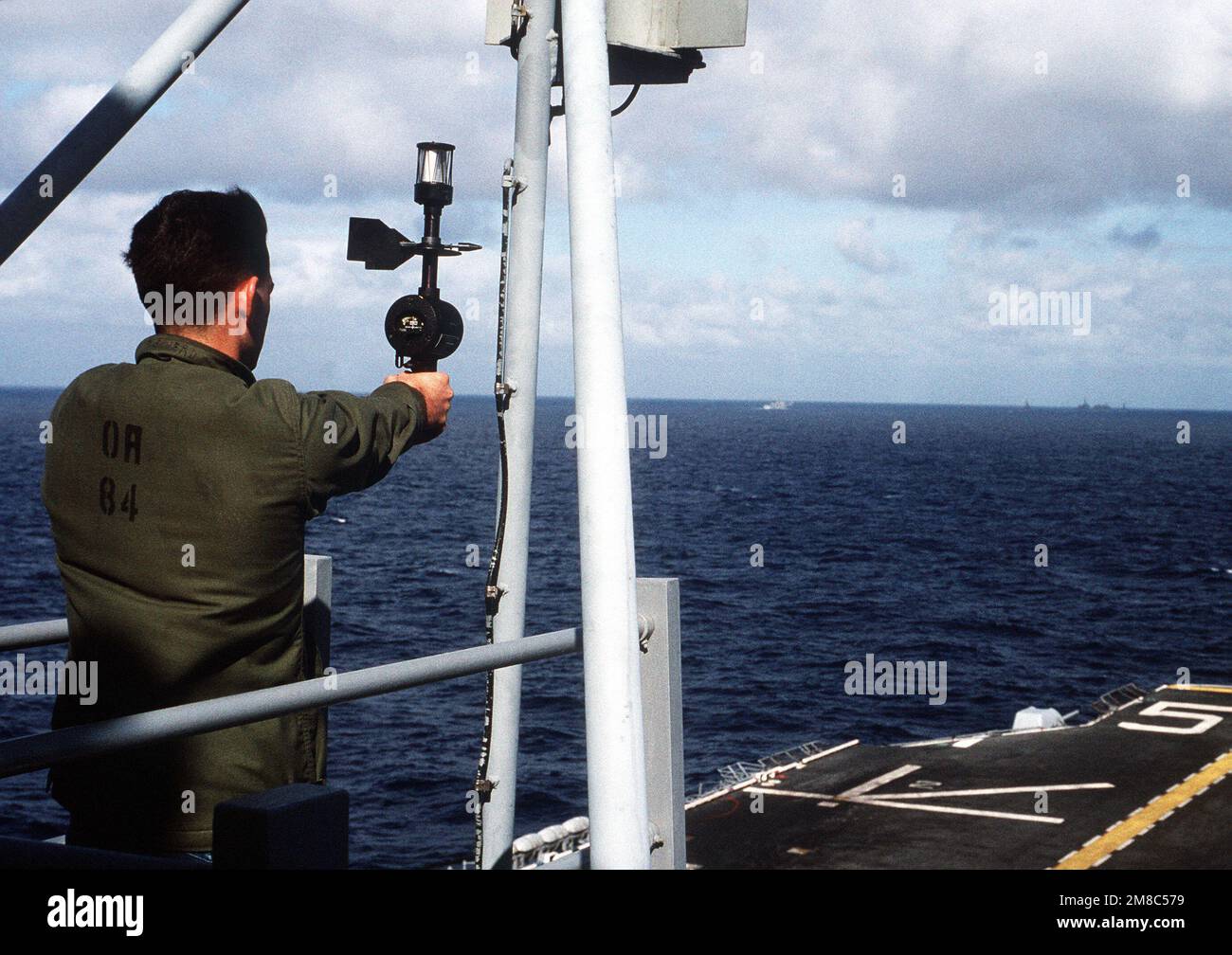 An aerographer's mate uses a hand-held anemometer Wind Measuring Set AN ...