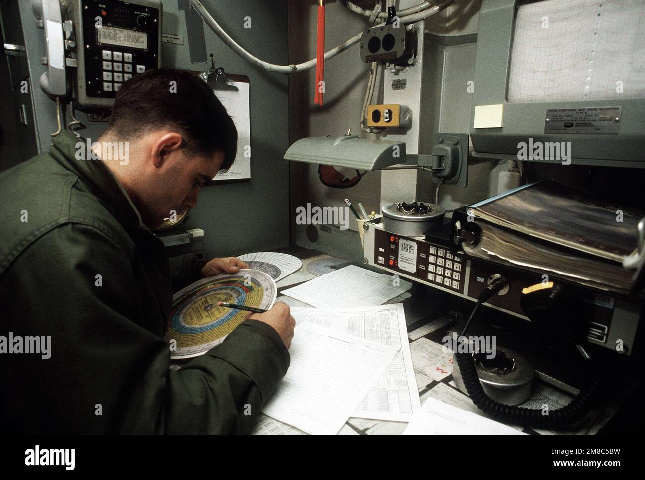 An aerographer's mate uses a plastic disc computer aboard the ...