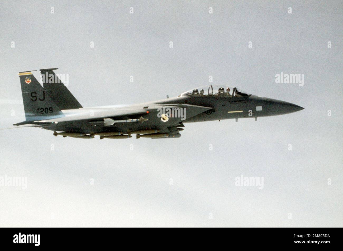 An air-to-air right side view of an F-15E Eagle aircraft, piloted by LT ...