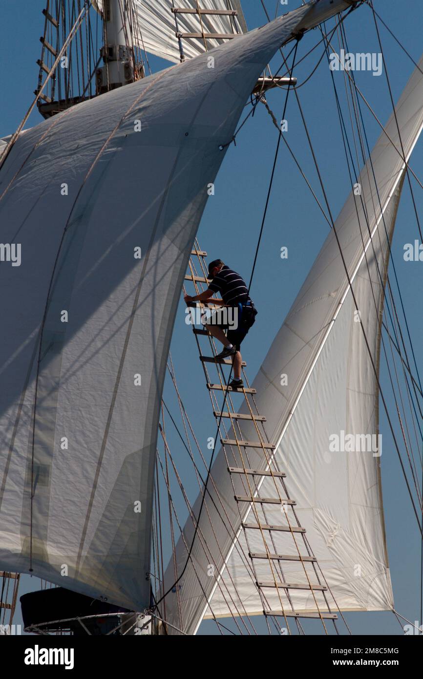 sailor climbing aloft on the foremast of Australian brigantine Yung ...