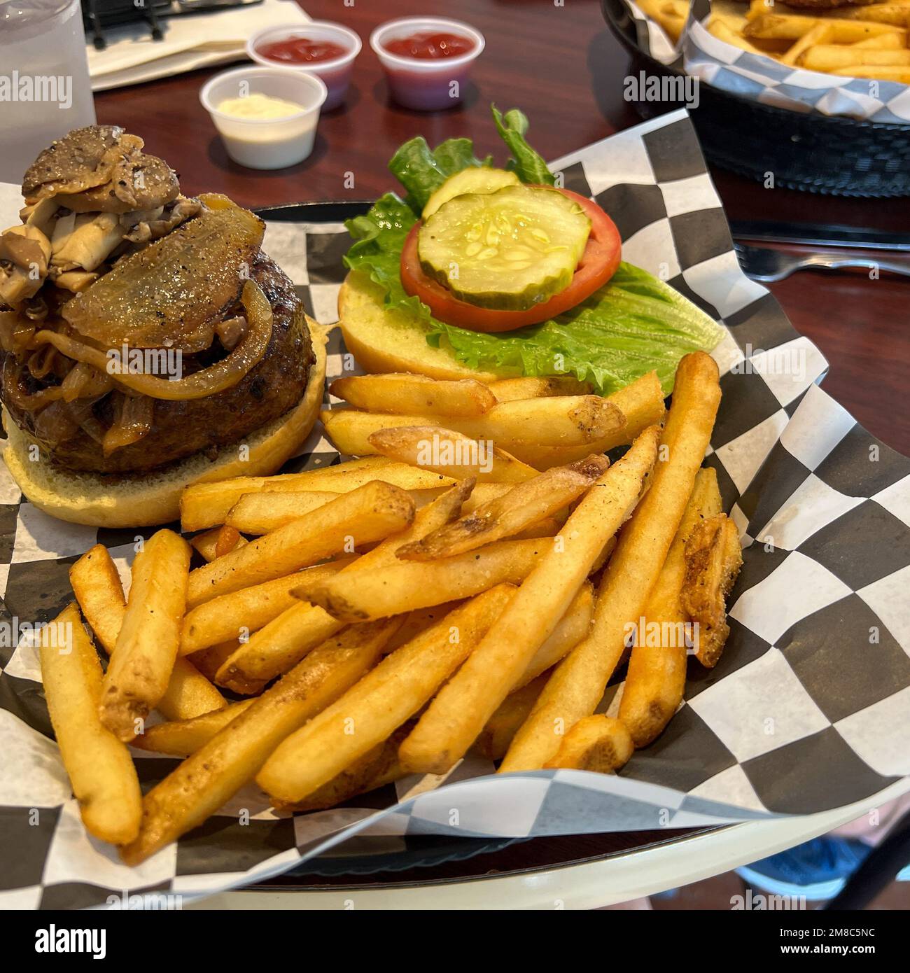 A delicious hamburger and french fries in a basket at a restaurant ...