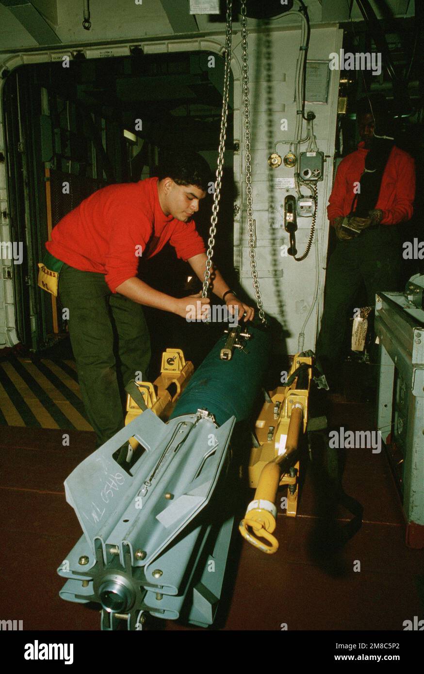 An ordnanceman on the aircraft carrier USS CONSTELLATION (CV 64 ...