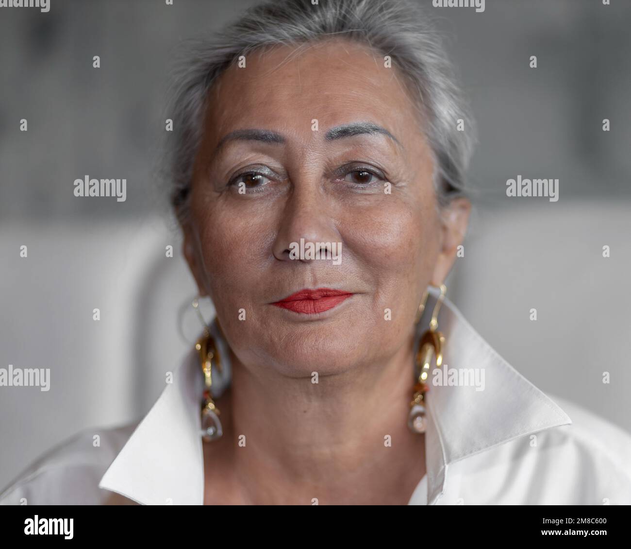 Portrait Of A Beautiful Mature Woman In A White Shirt With Long