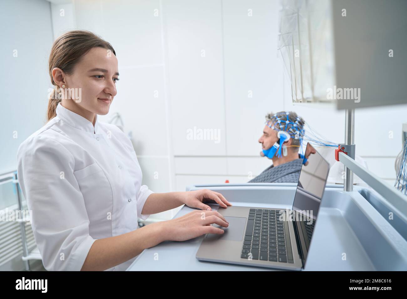 Doctor conducts diagnostic procedure for EEG - electroencephalography ...