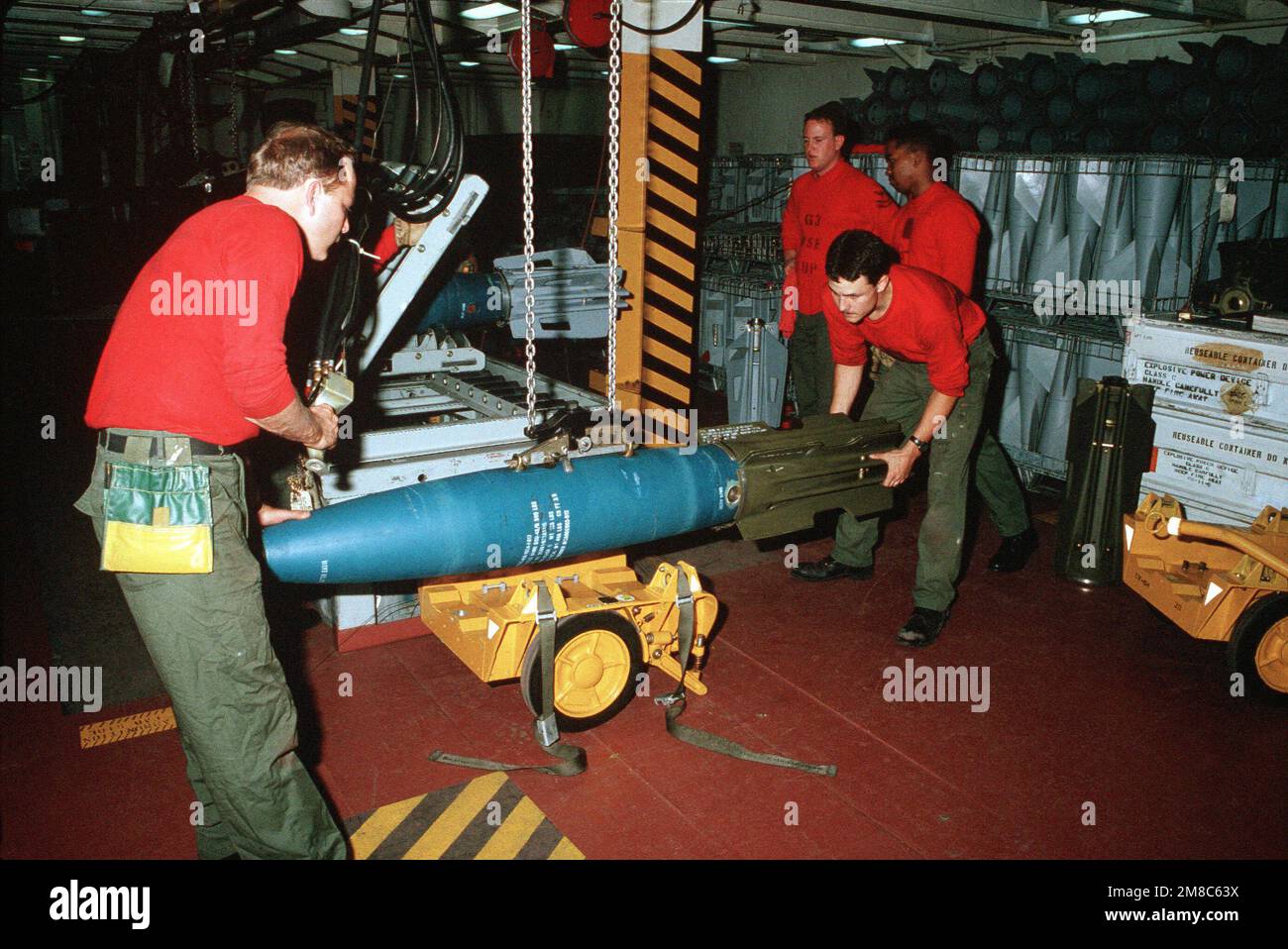 Ordnancemen on the aircraft carrier USS CONSTELLATION (CV 64) hoist a ...