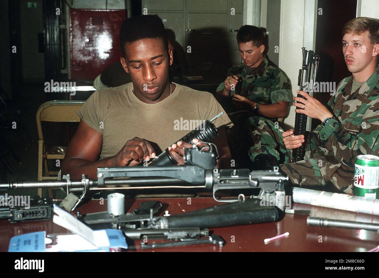 A Marine aboard the amphibious assault ship USS PELELIU (LHA-5) cleans ...