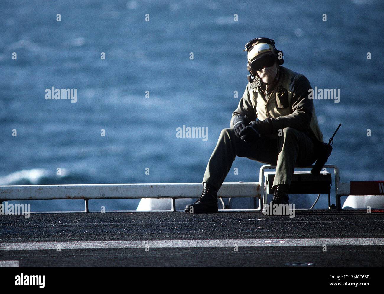 A flight deck crew member wears cold weather gear aboard the amphibious ...