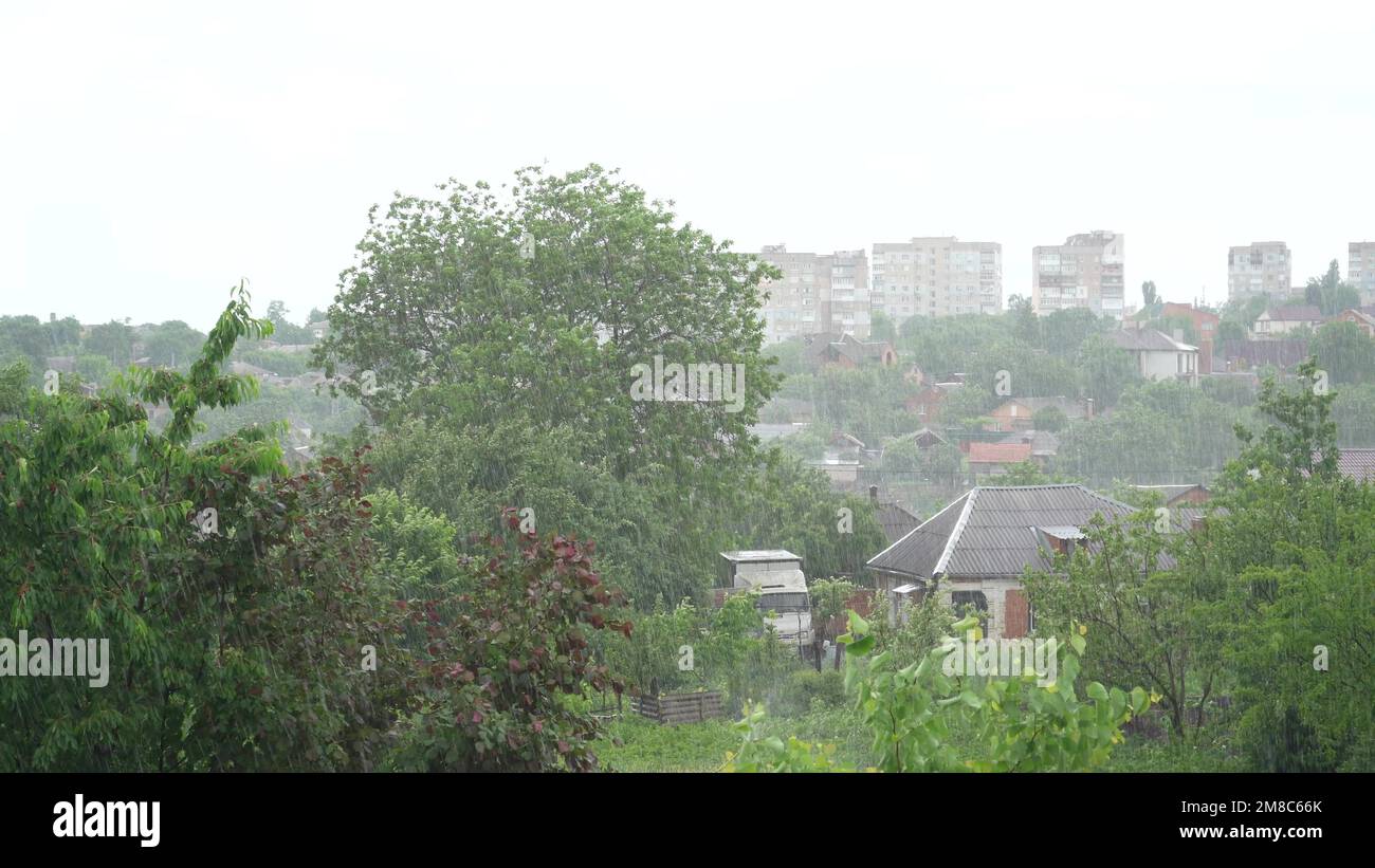 Heavy rain pouring down on roof of house. Storm rain at countryside ...