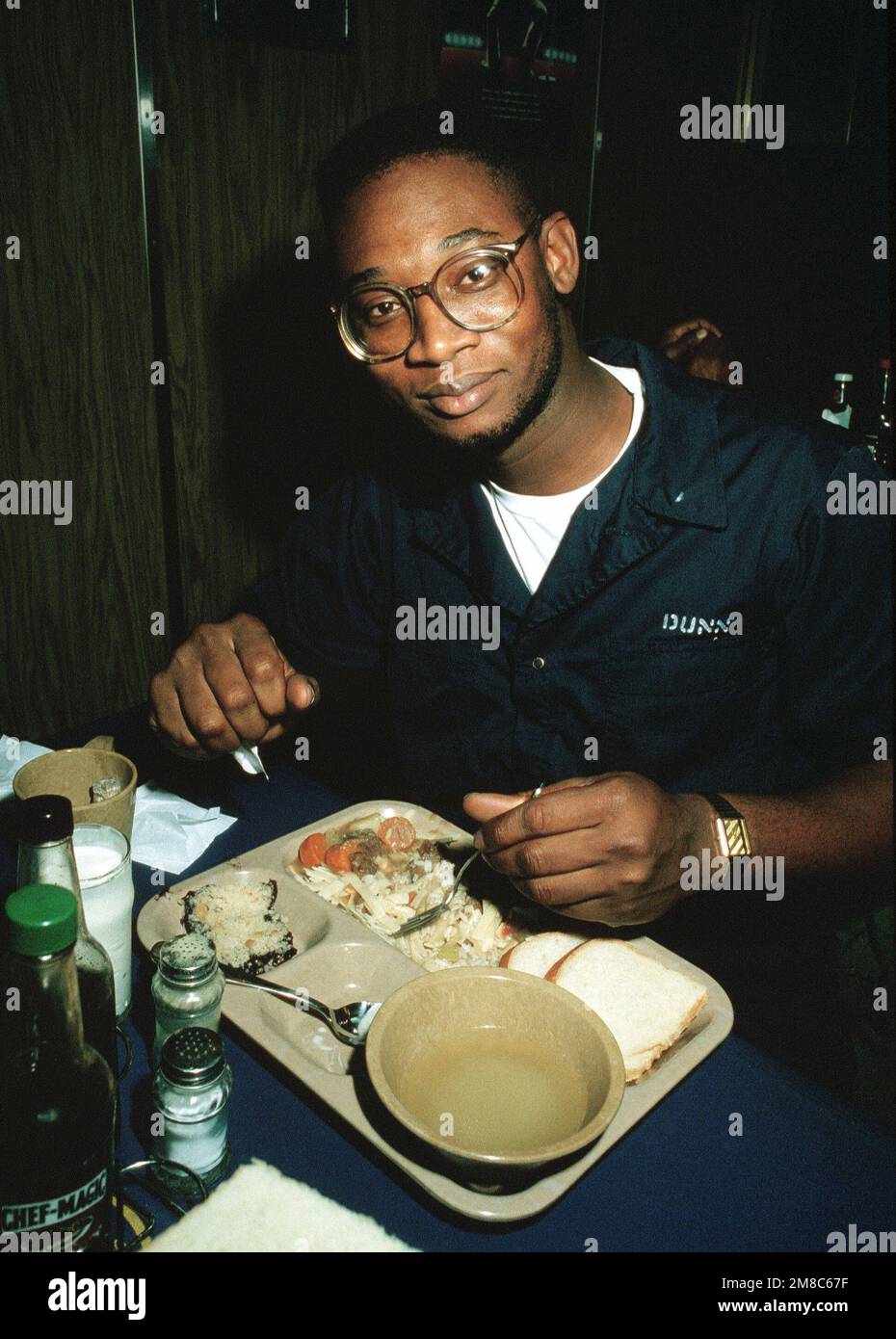 A crew member eats a meal aboard the aircraft carrier USS CONSTELLATION ...