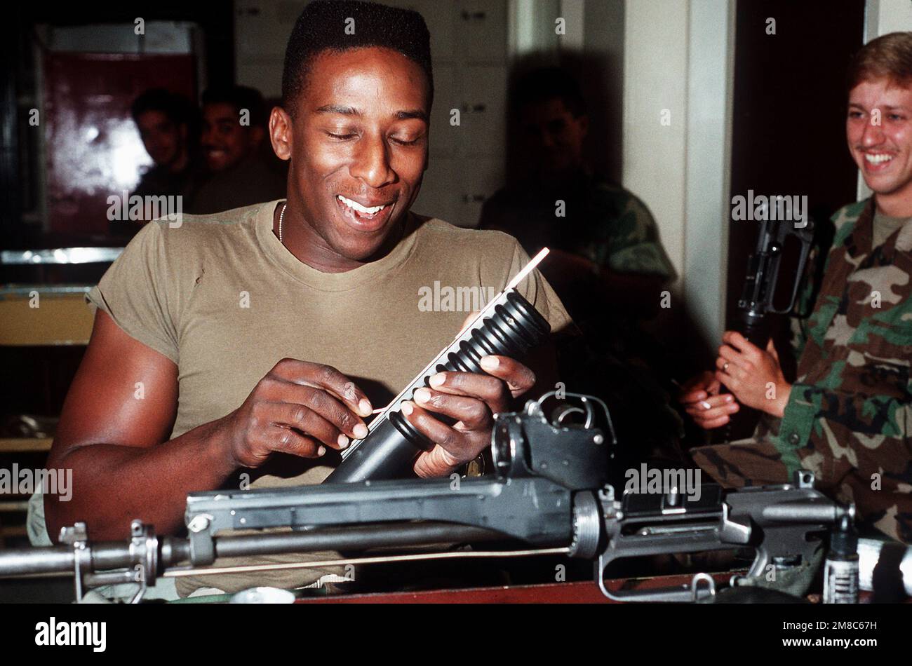 A Marine aboard the amphibious assault ship USS Peleliu (LHA-5) cleans ...
