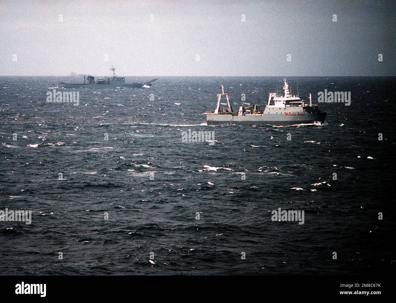 A commercial craft passes the tank landing ship USS Schenectady (LST ...