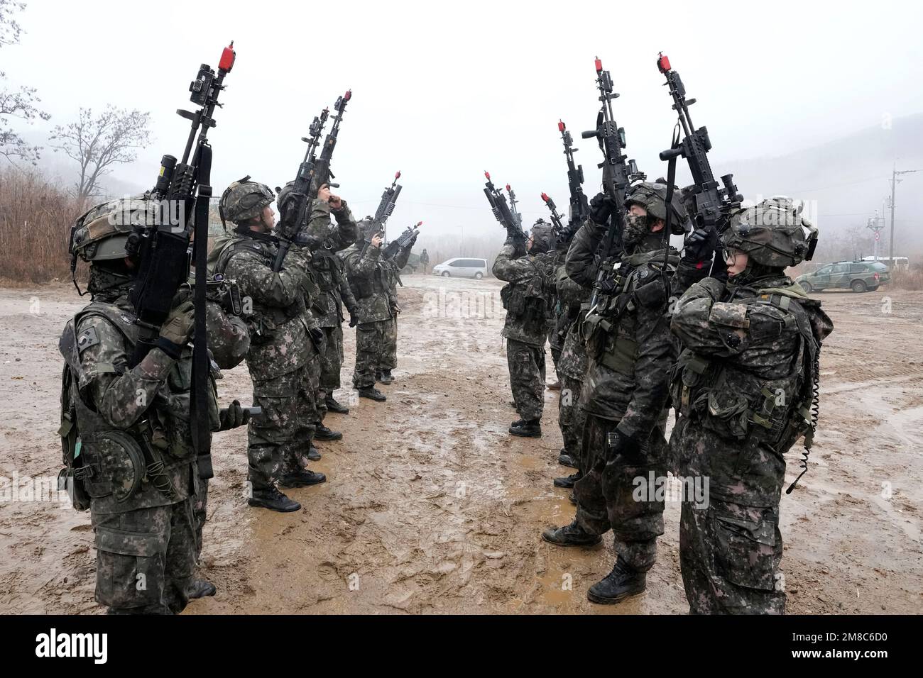South Korean army soldiers check their machine guns after a joint ...