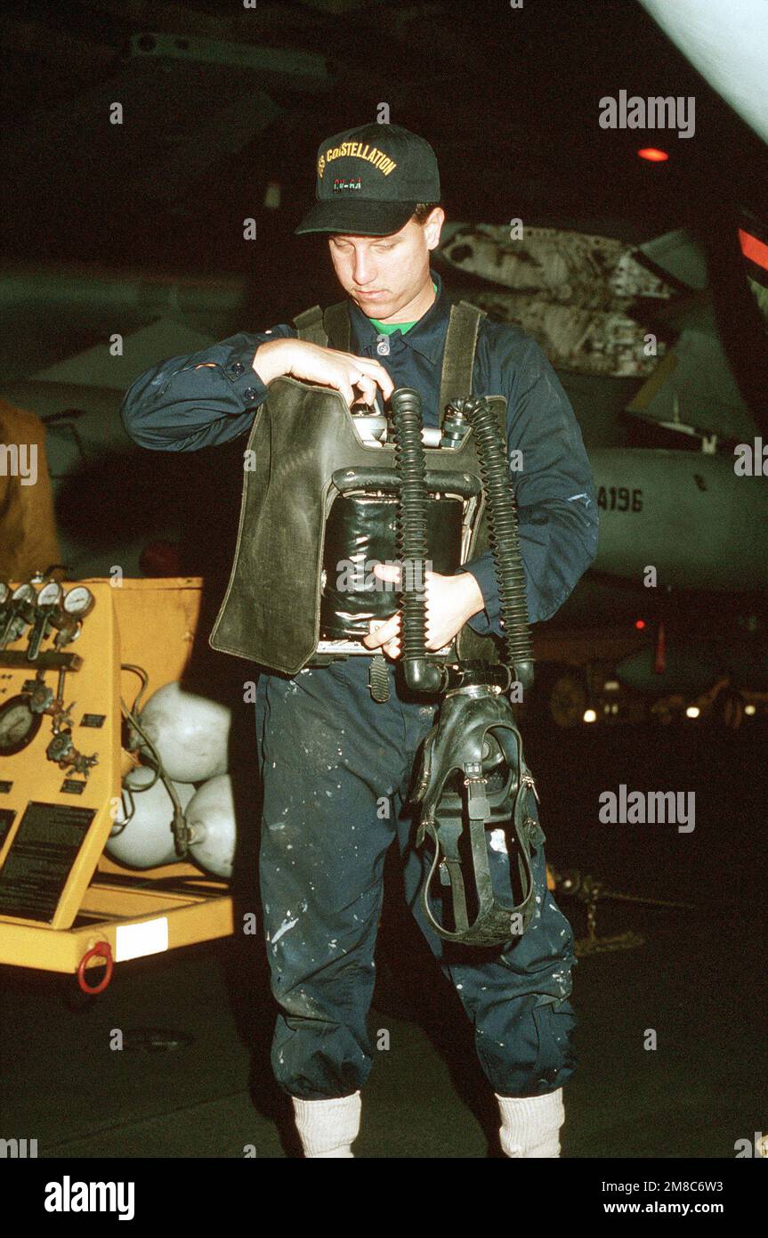 A sailor sets the timer on his oxygen breathing apparatus (OBA) prior ...