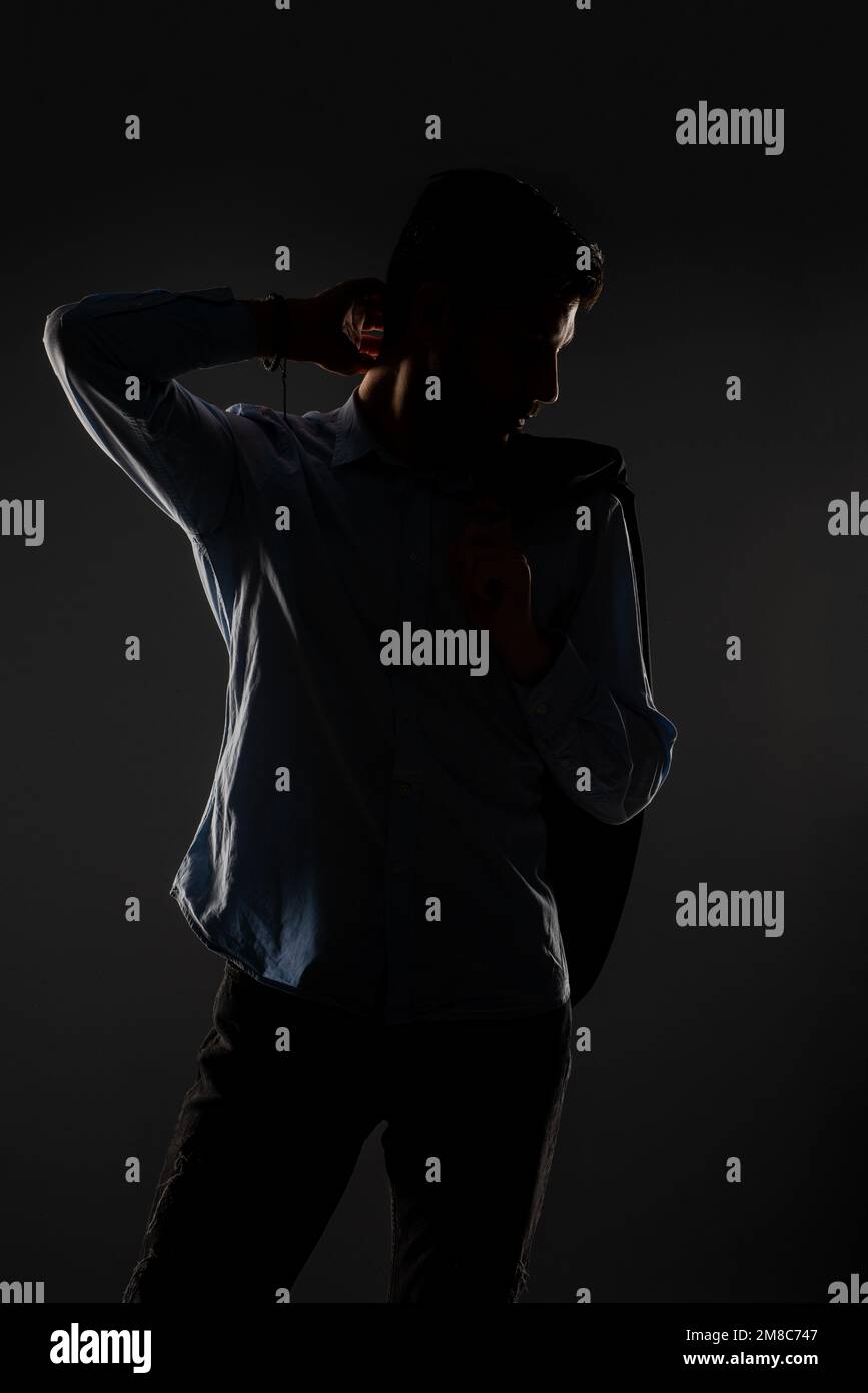 Attractive and handsome man in the studio setting himself up for the ...