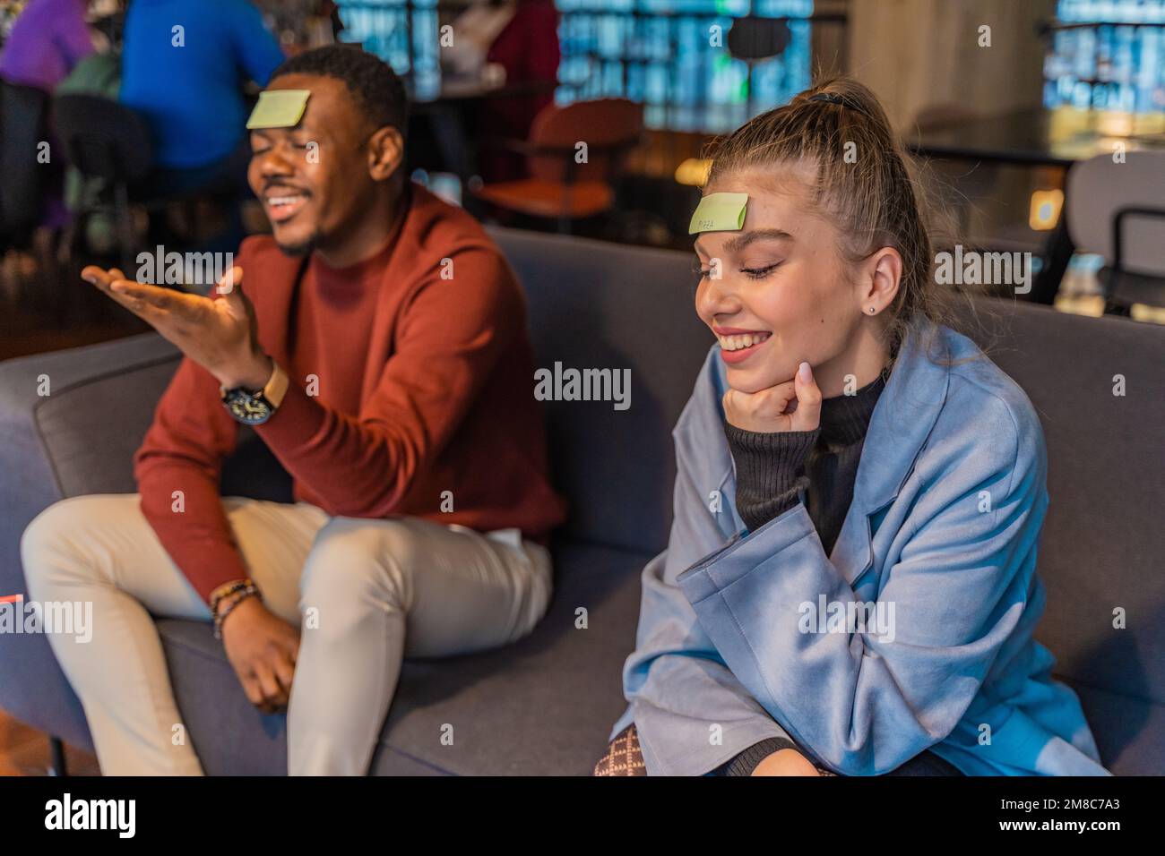 Multiracial friends are laughing and guessing their word Stock Photo ...