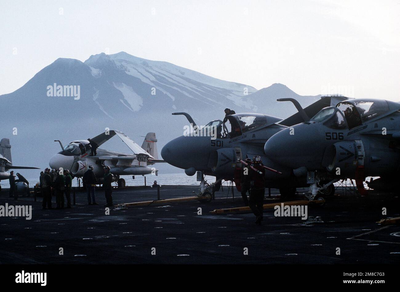 Flight deck crew members service A-6E Intruder aircraft aboard the ...