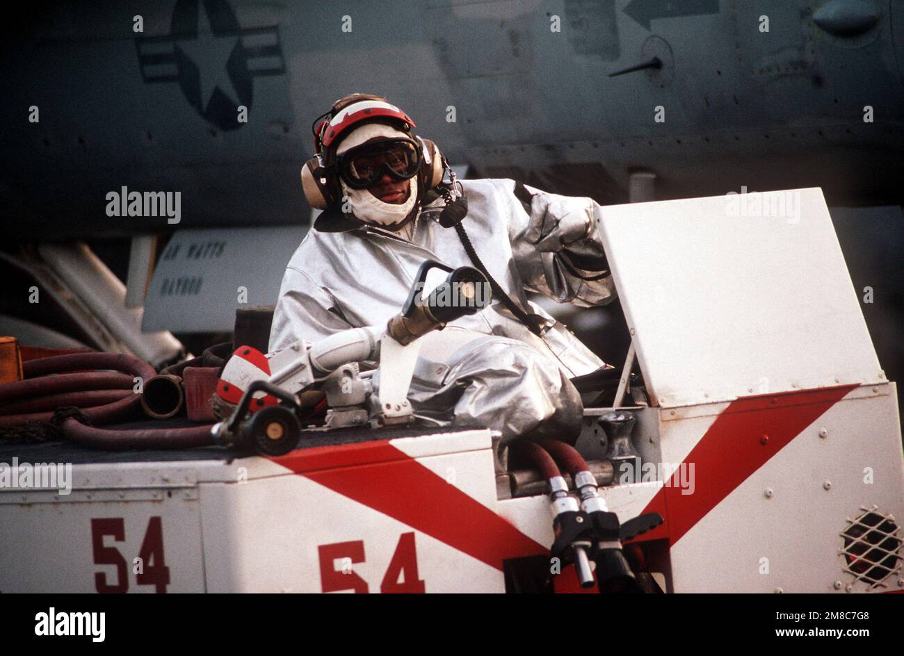 A firefighter stands by in a P-16 firefighting and rescue truck aboard ...