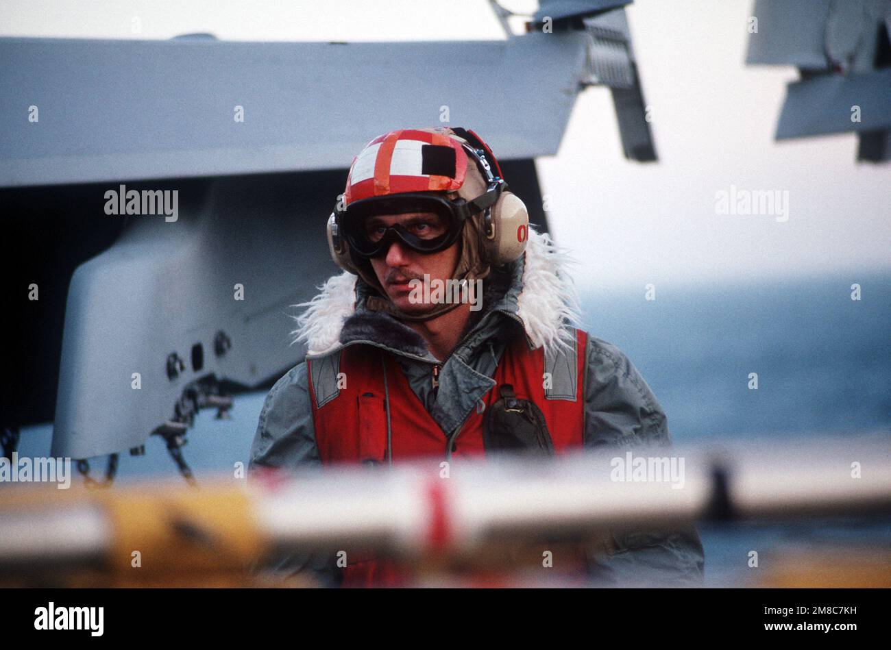 A flight deck crew member stands by on the flight deck of the aircraft ...