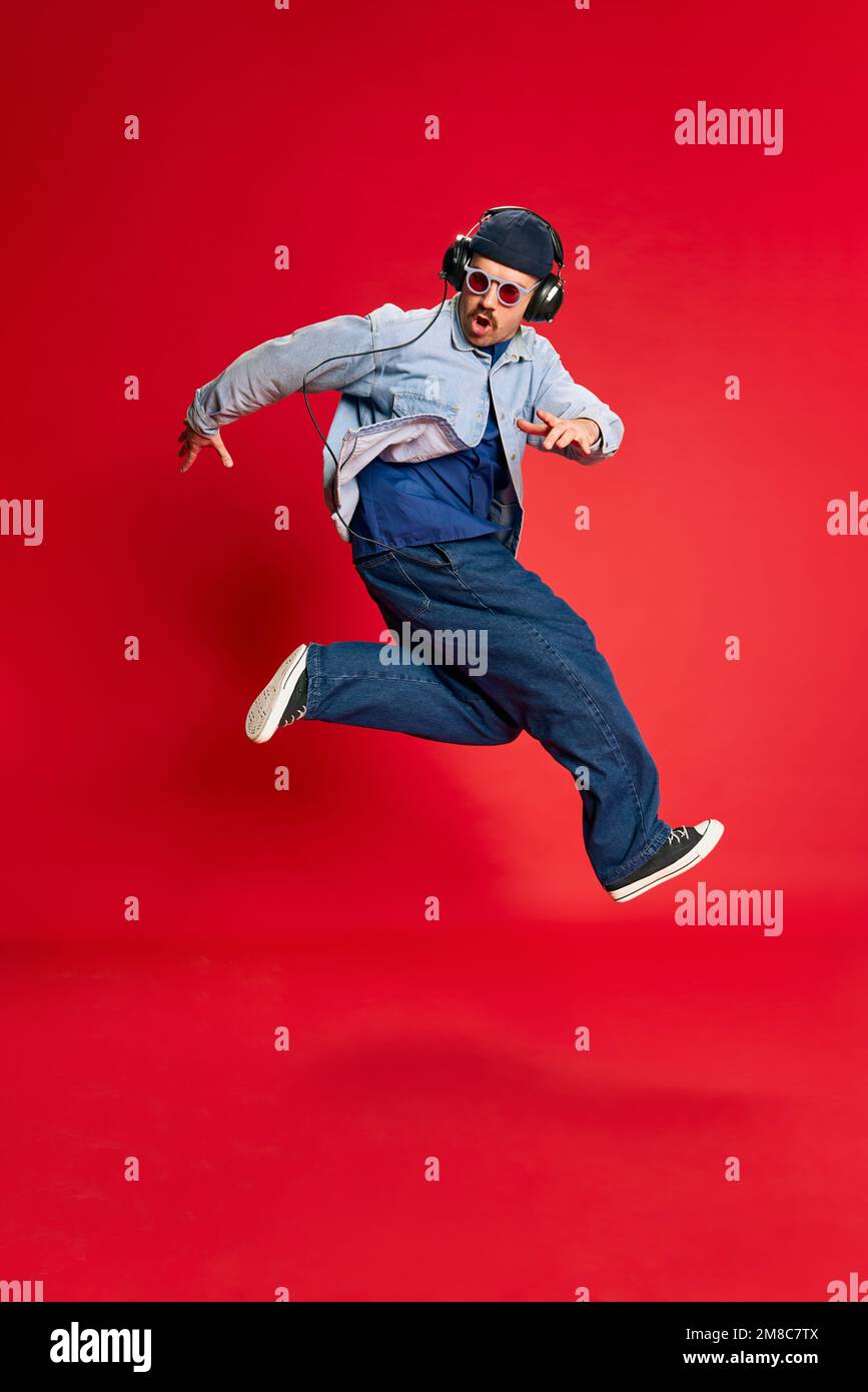 Party. Portrait of man in stylish clothes, oversized jeans, shirt and ...