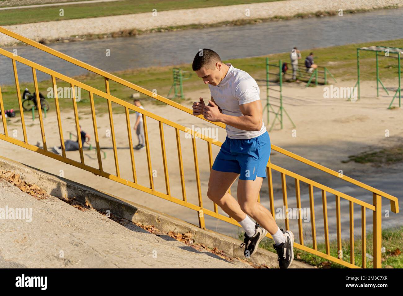 Attractive and handsome fit guy is jumping alone Stock Photo - Alamy