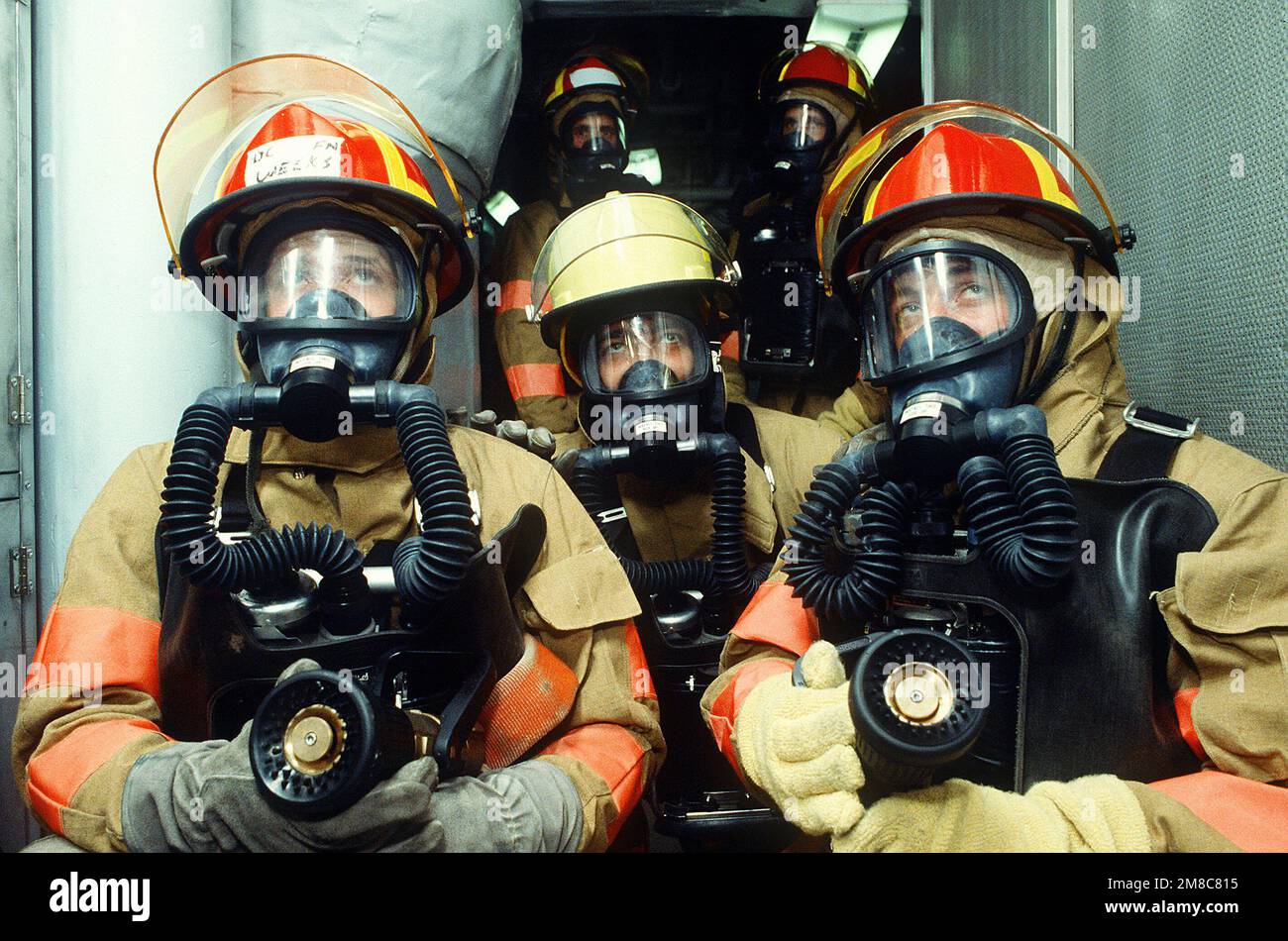 Crew members wearing A-4 oxygen breathing apparatus take part in a ...