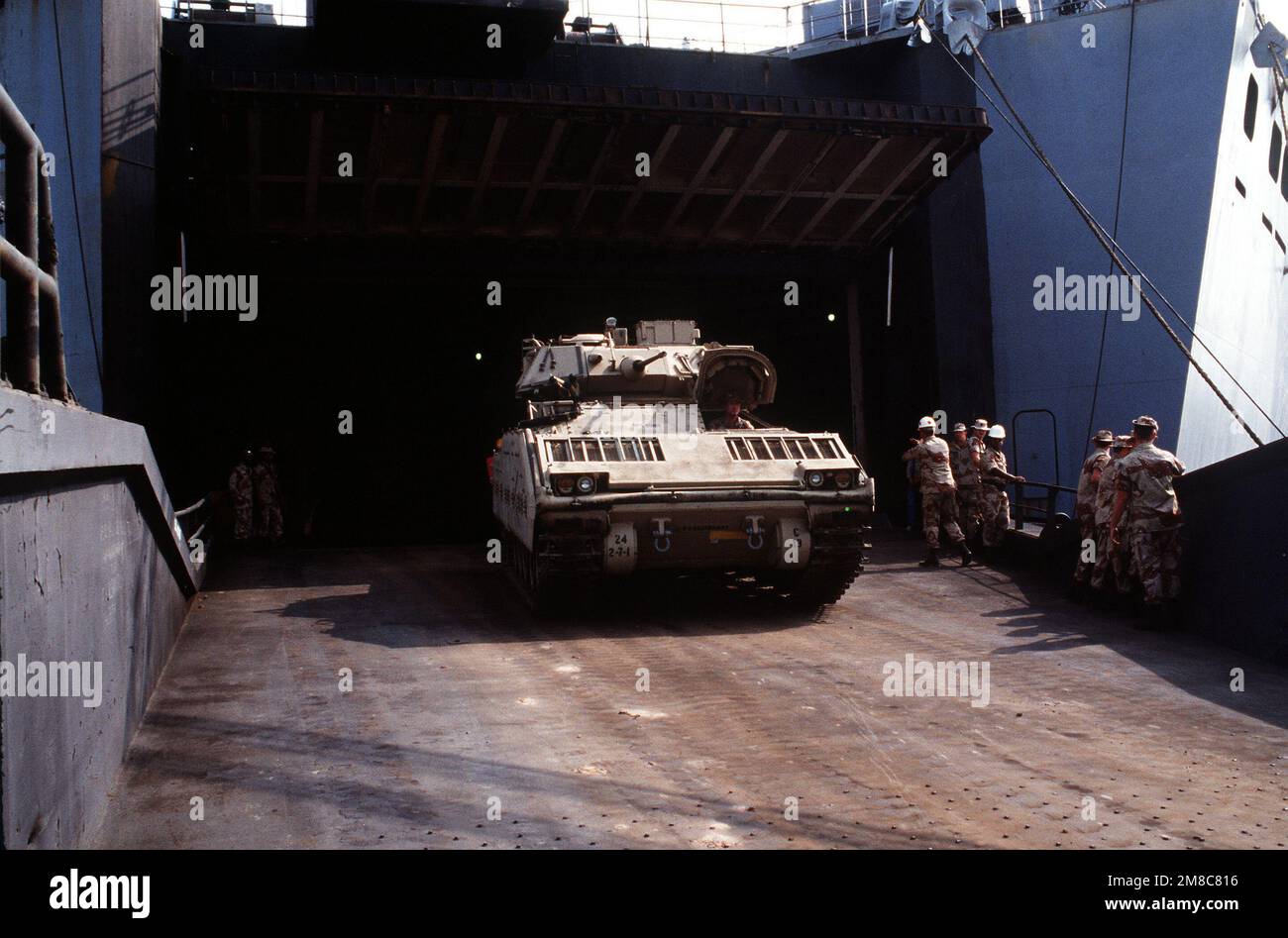 An M-2 Bradley infantry fighting vehicle is offloaded from the ...