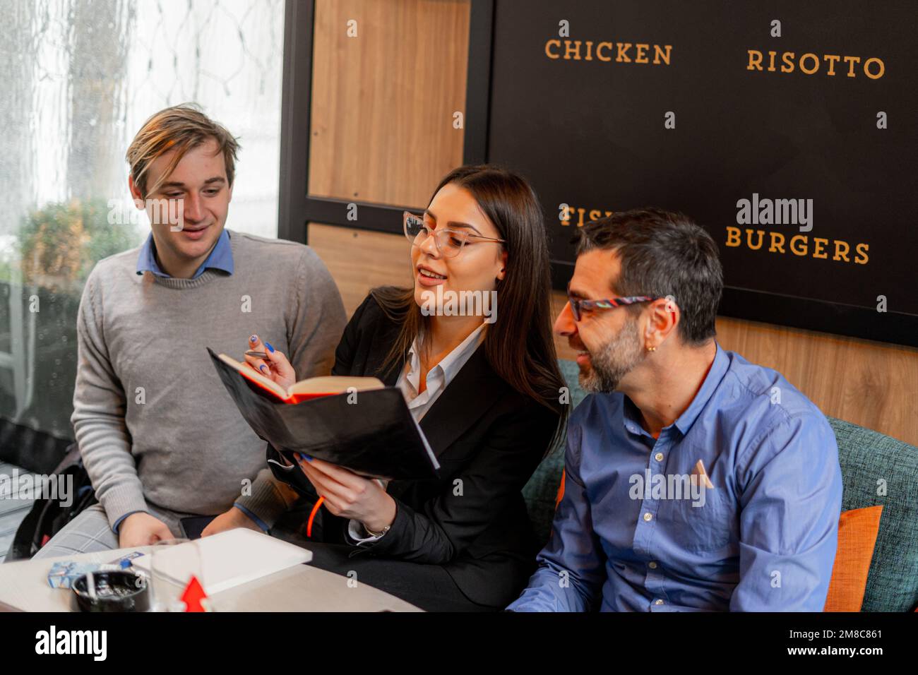 Three business people are making plans and giving ideas Stock Photo - Alamy