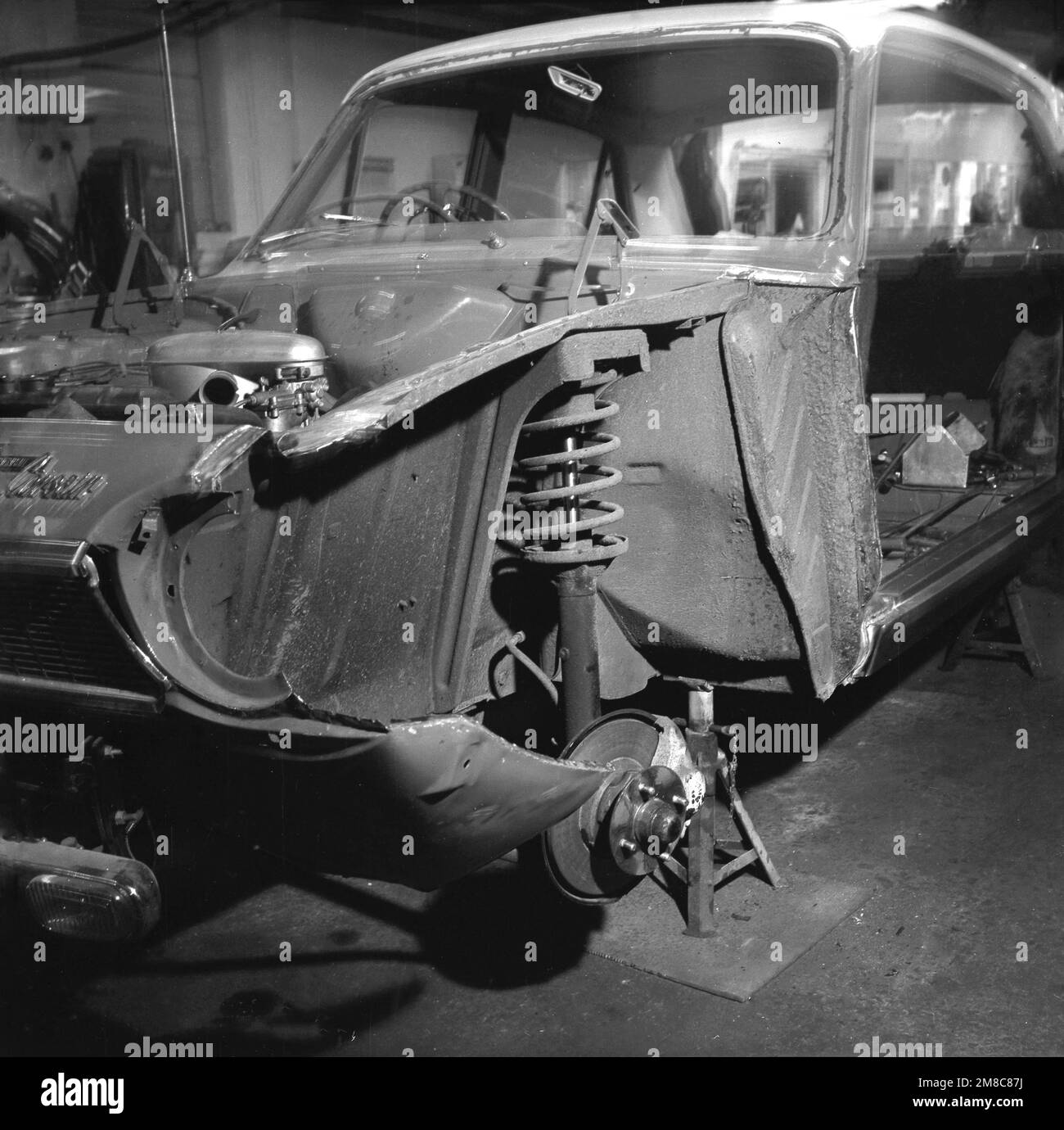 1950s, historical, car of the car era inside garage, being repaired ...