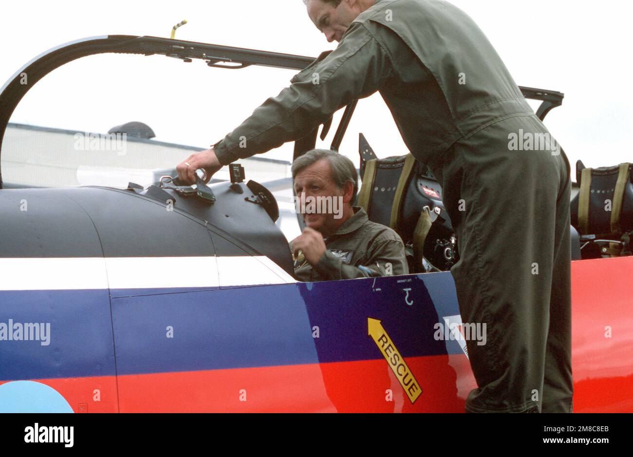 A pilot checks over the cockpit of a Pilatus PC-9 aircraft before ...