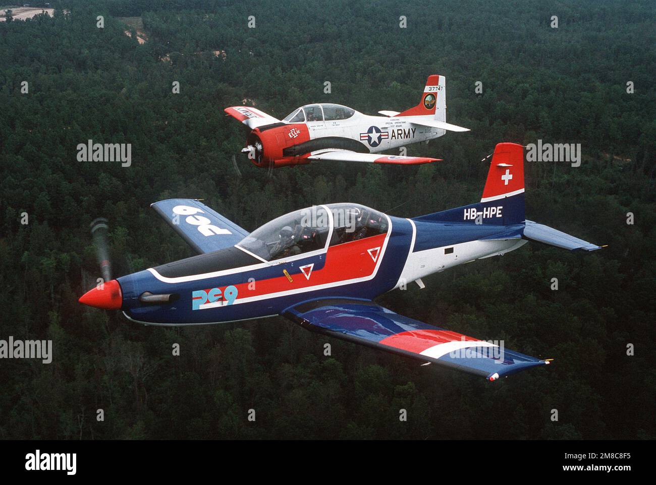 A Pilatus PC-9 aircraft, foreground, and an Army T-28B Trojan aircraft ...